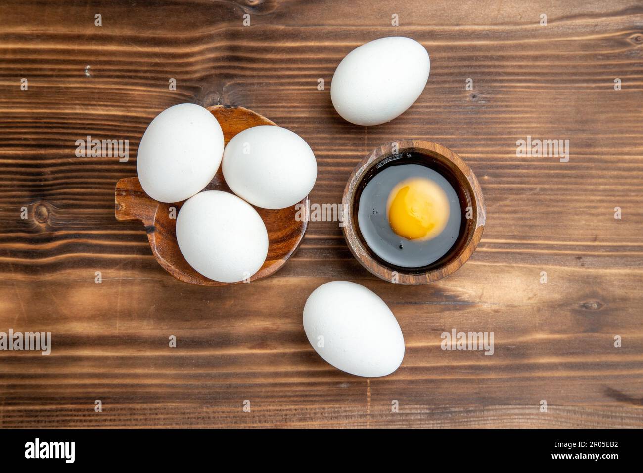 top view whole raw eggs on brown wooden background meal food breakfast ...