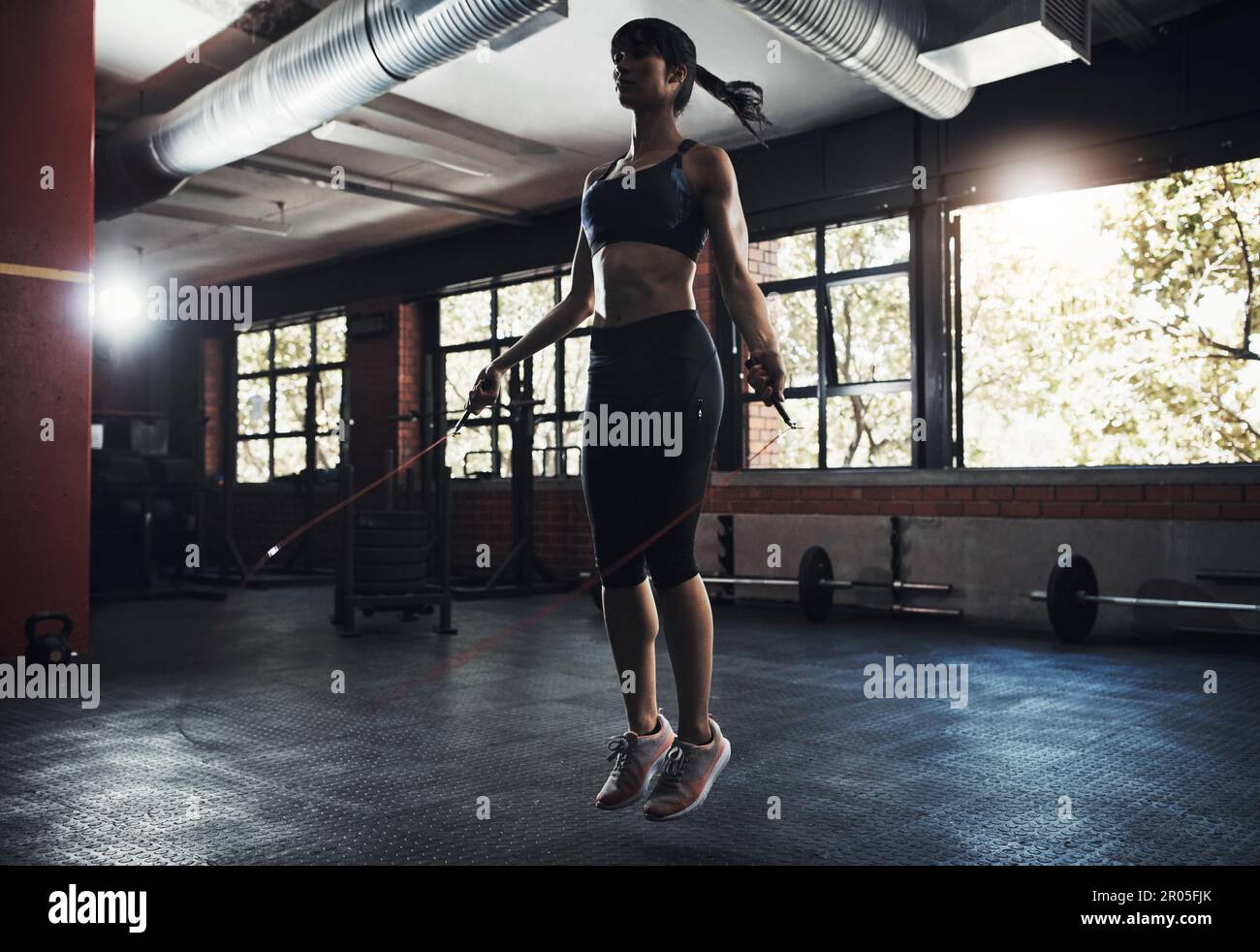 Jumping towards a healthier lifestyle. a beautiful young woman jumping ...