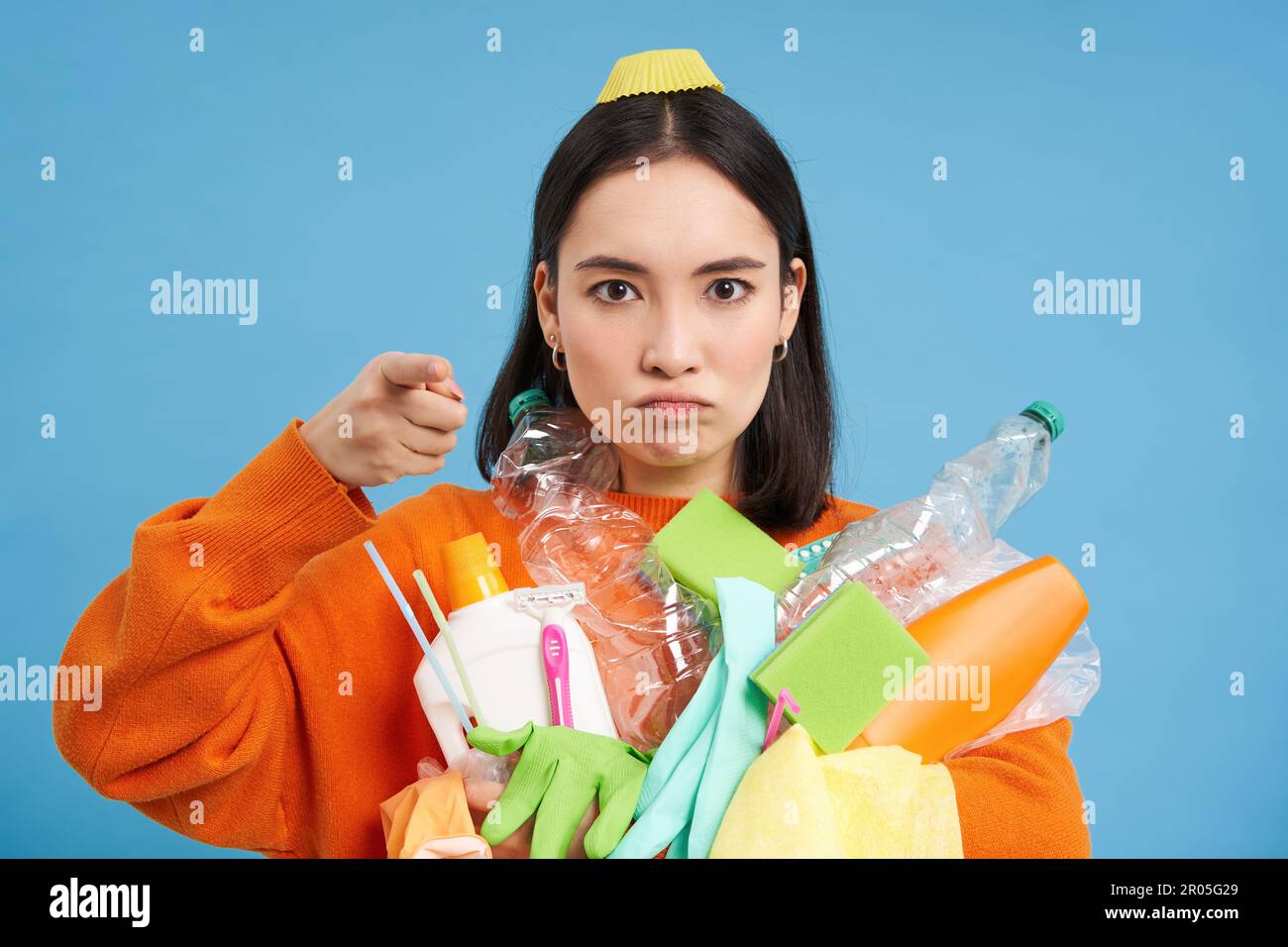 Serious korean woman pointing finger at camera, blame people for ...