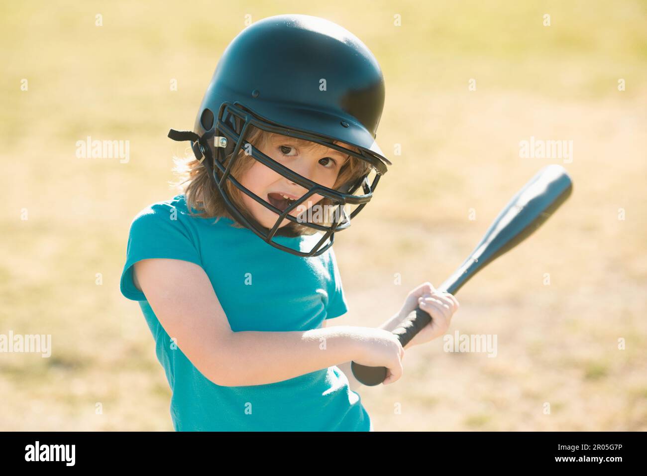 Funny boy kid holding a baseball bat. Pitcher child about to throw in ...