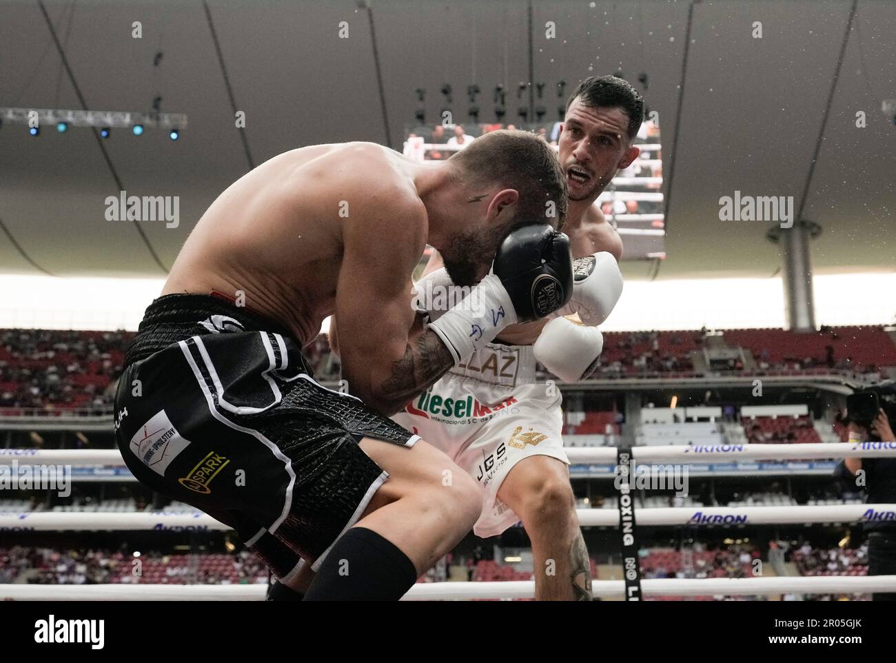 Gabriel Gollaz Valenzuela, of Mexico, back, strikes Steve Spark, of ...