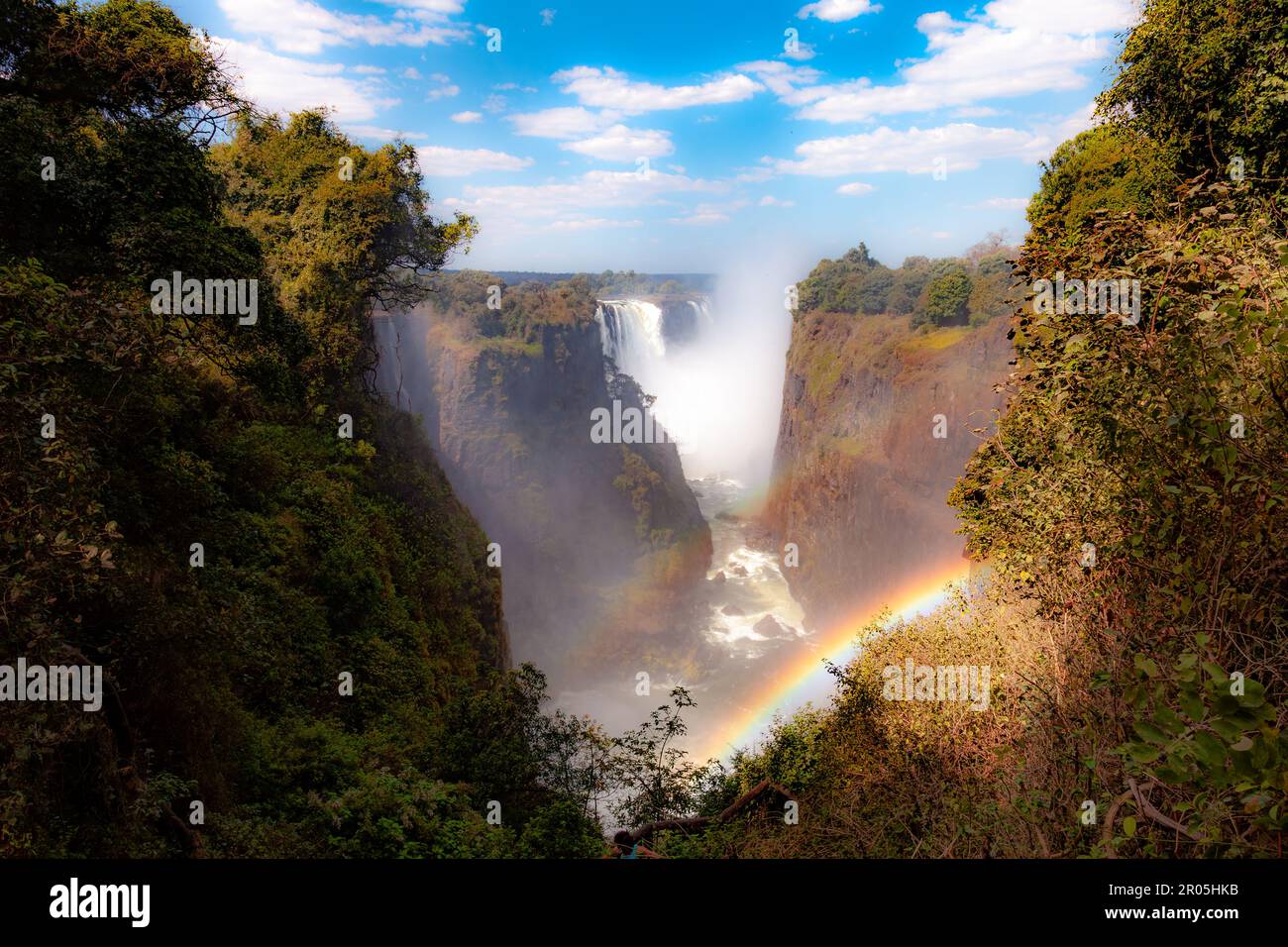 A double rainbow forms as the Zambezi River plunges over the ...
