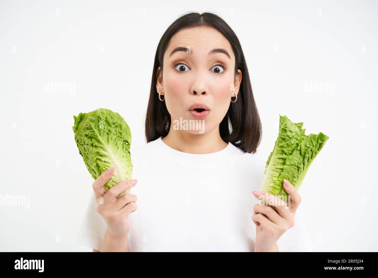 Healthy diet and organic food. Smiling asian woman showing cabbage ...