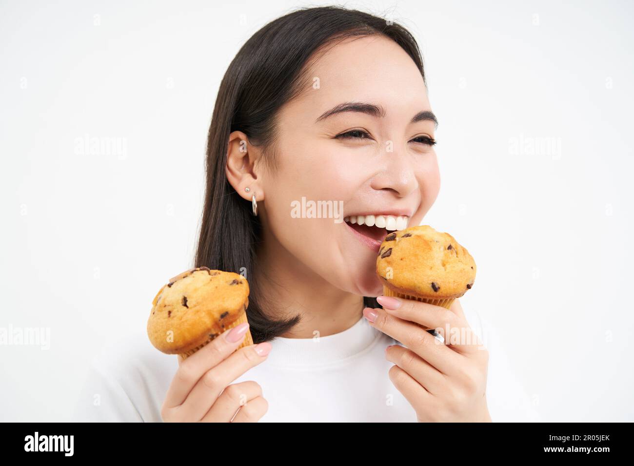 Close up portrait of happy, beautiful smiling woman, eating pastry ...