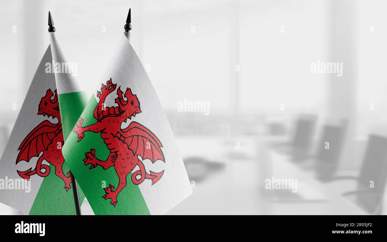 Small flags of the Wales on an abstract blurry background Stock Photo ...