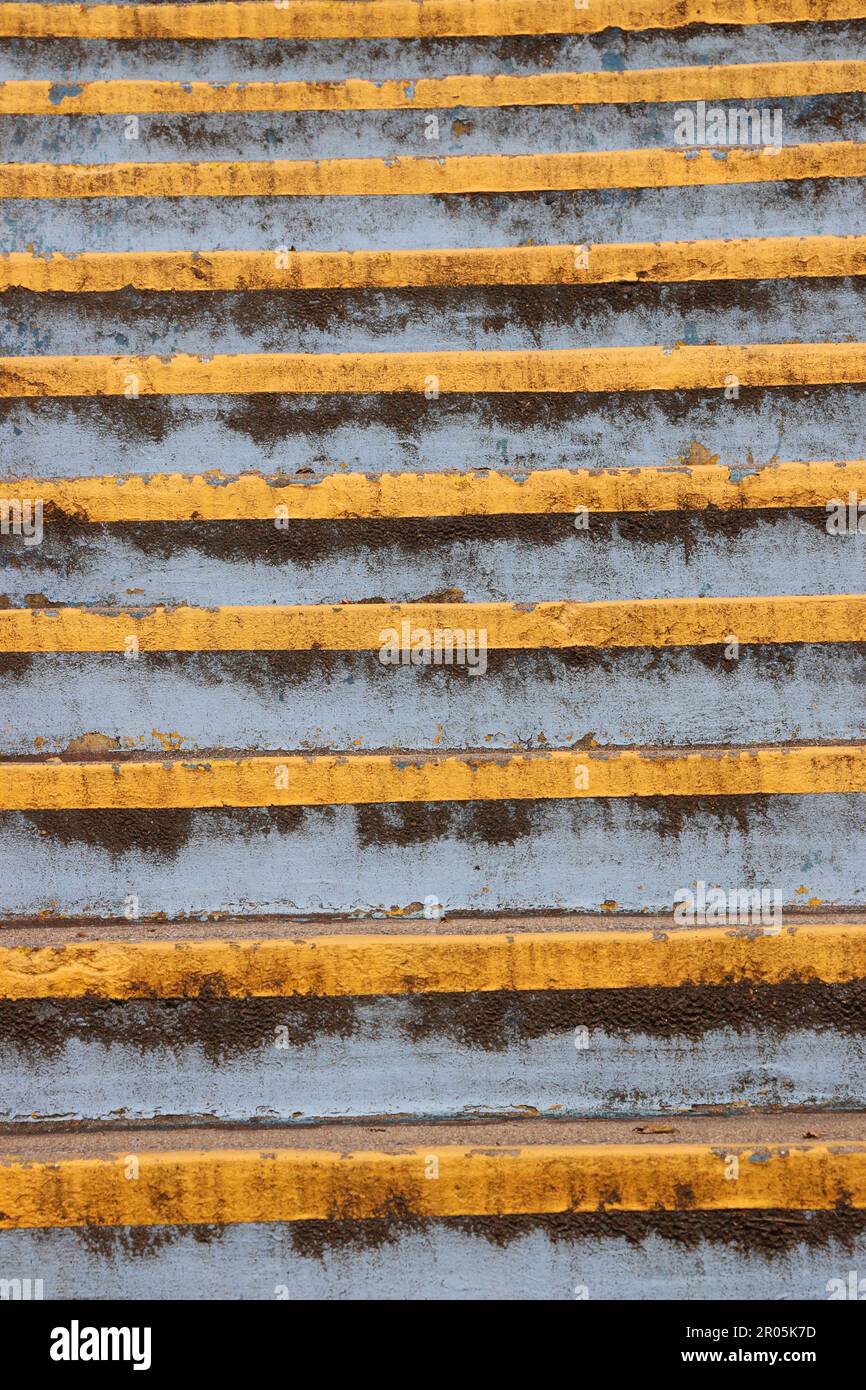 Close up retro image of weathered blue stairs with yellow stripes Stock ...
