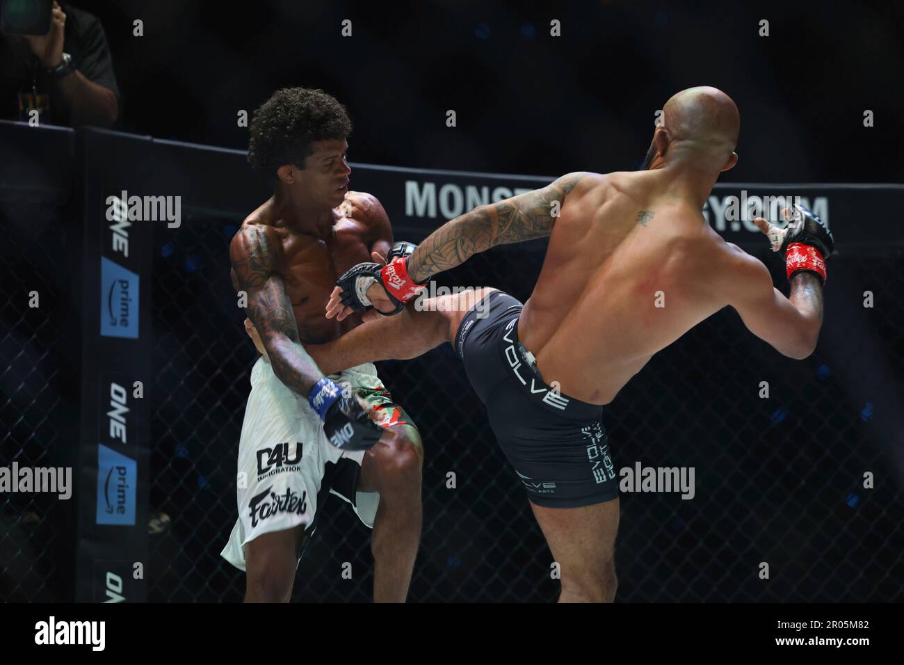 DENVER, COLORADO - MAY 5: (R-L) Demetrious Johnson lands a kick on ...