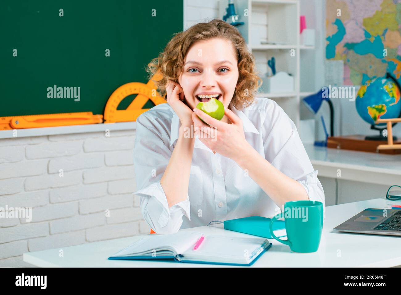 Teacher school lunch. Education. Eating in classroom. Study and ...
