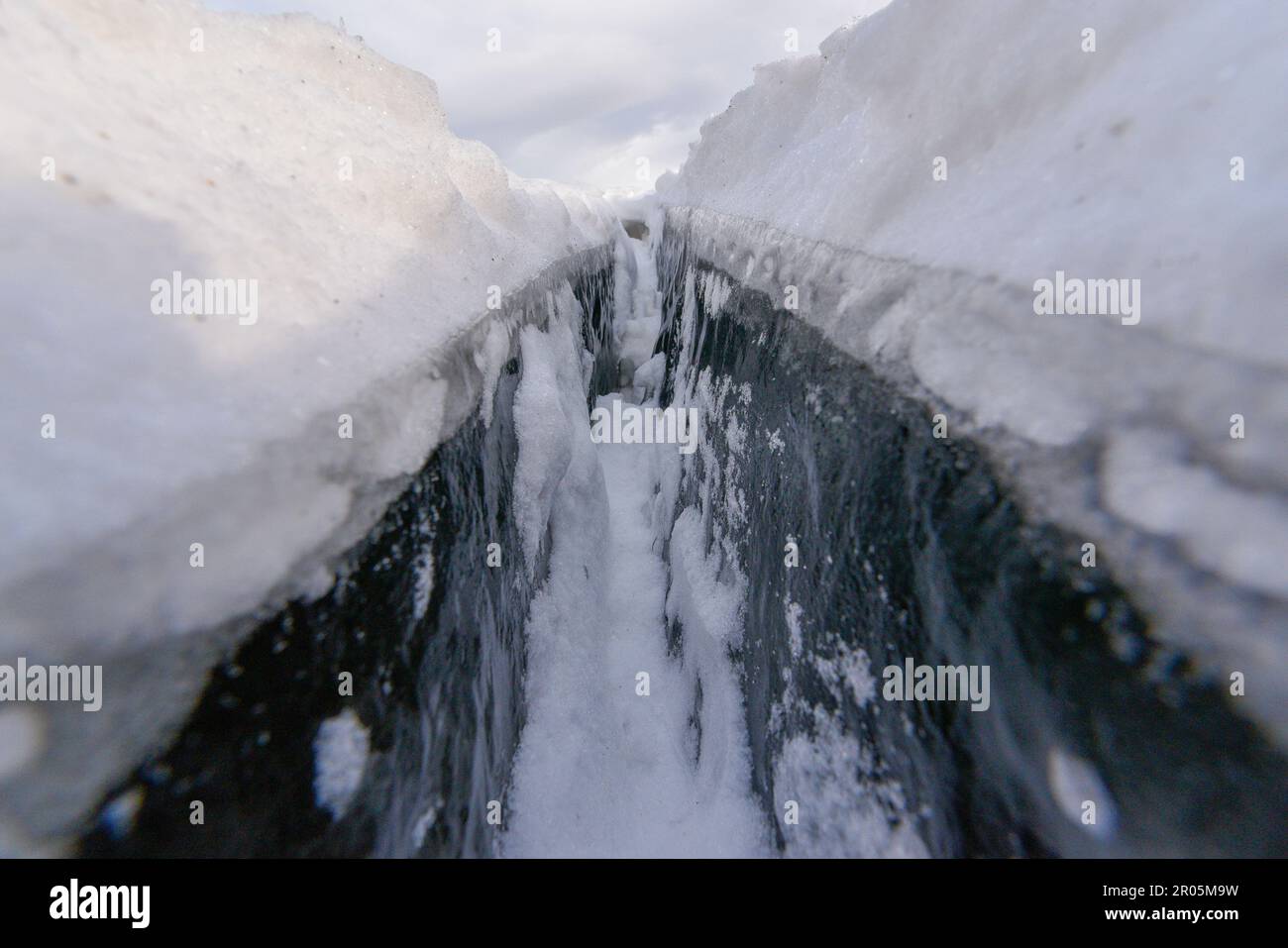 Frozen cracks in the ice along the Yukon River in winter season outside ...