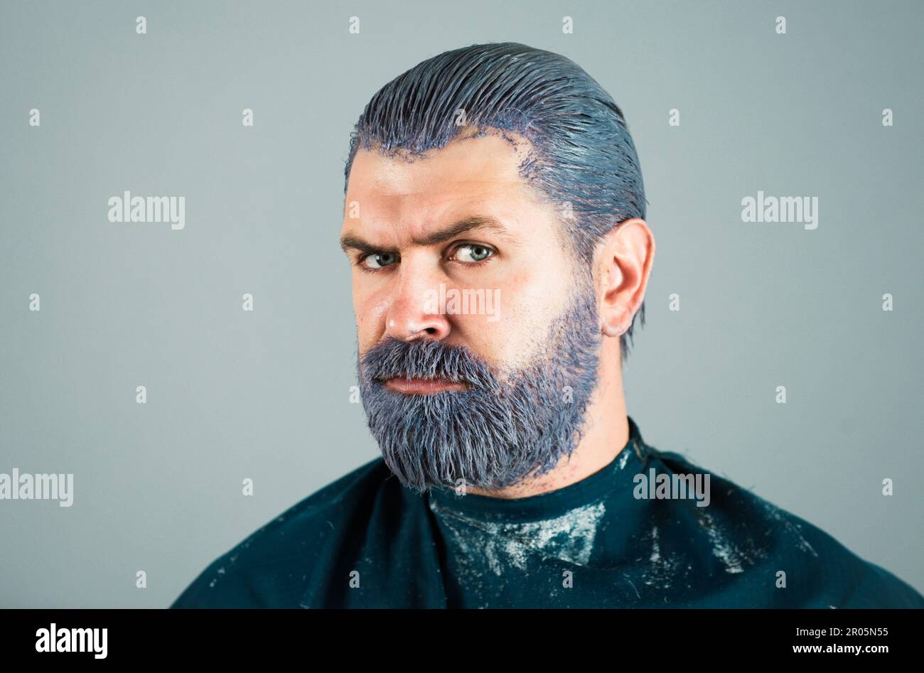Man hair coloring. Bearded hipster guy. Process of a man having his ...