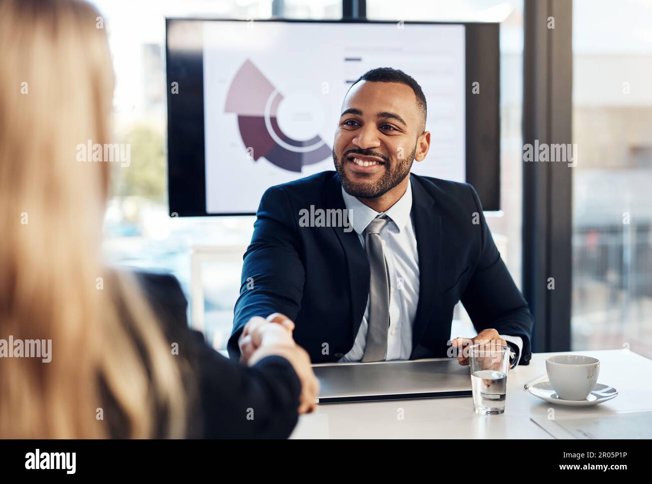 Stellar work as always. a young businessman and businesswoman shaking ...