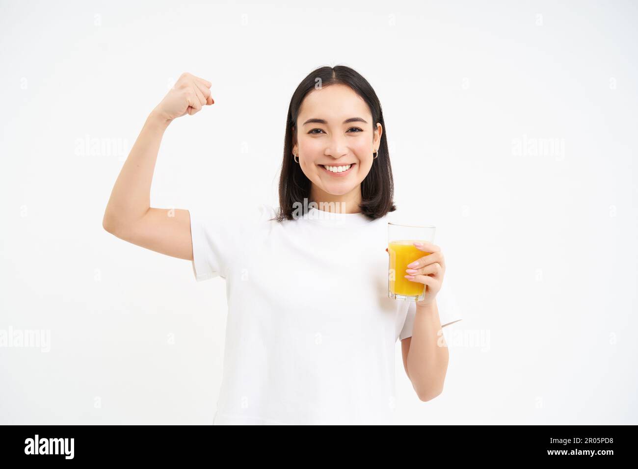 Healthy lifestyle. Smiling young asian woman, shows strong muscles ...