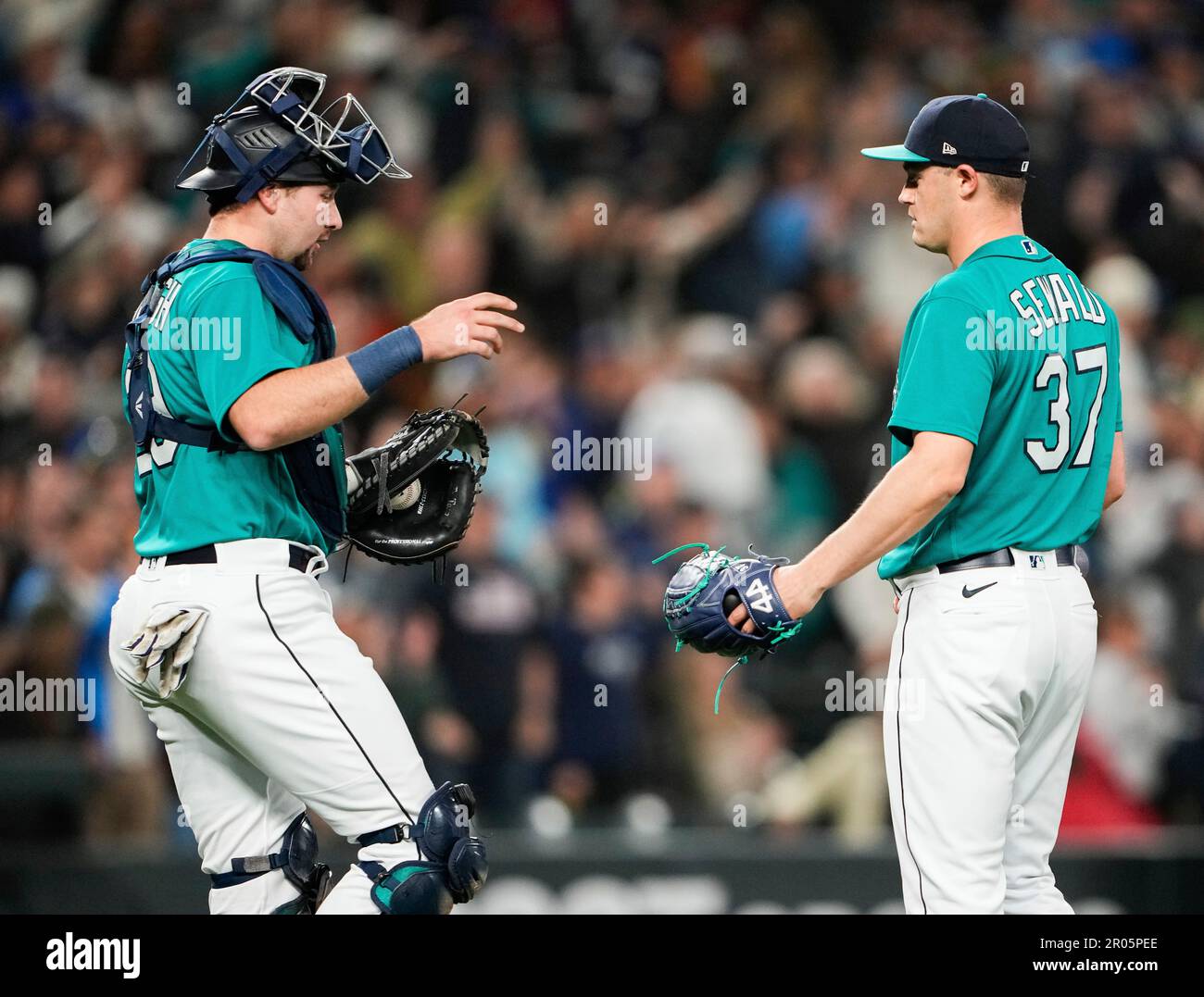 Seattle Mariners catcher Cal Raleigh greets relief pitcher Paul Sewald ...