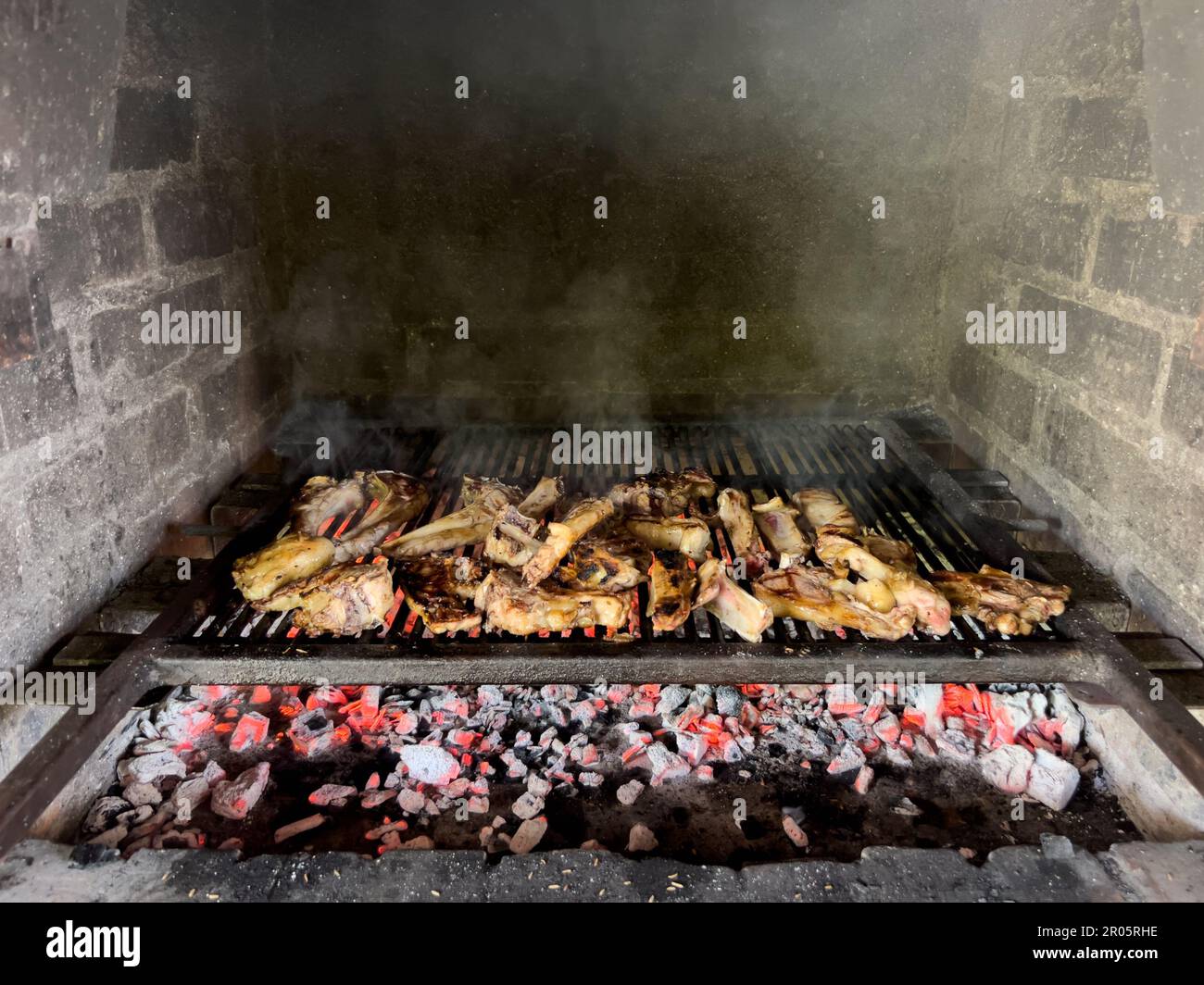 Ribs are grilled over burning coals in a brick oven Stock Photo - Alamy
