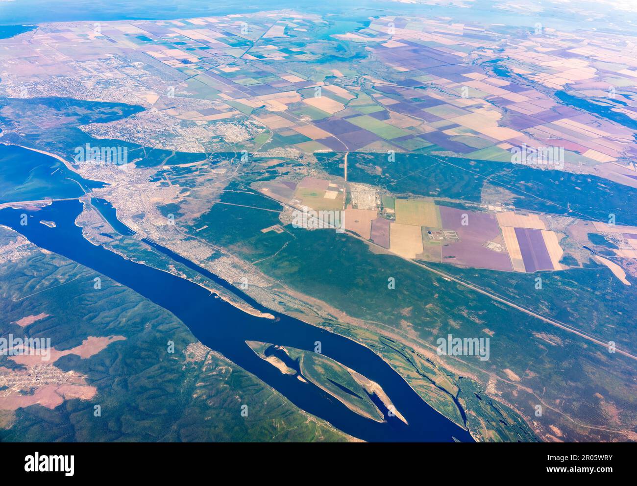 Aerial view from airplane window above green ground. View from the ...