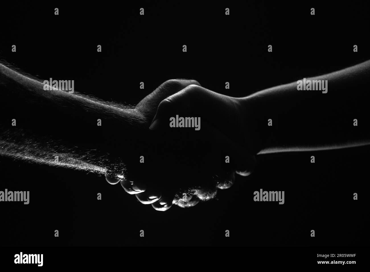 Handshake between the two partners, agreement. Male hands rescue ...