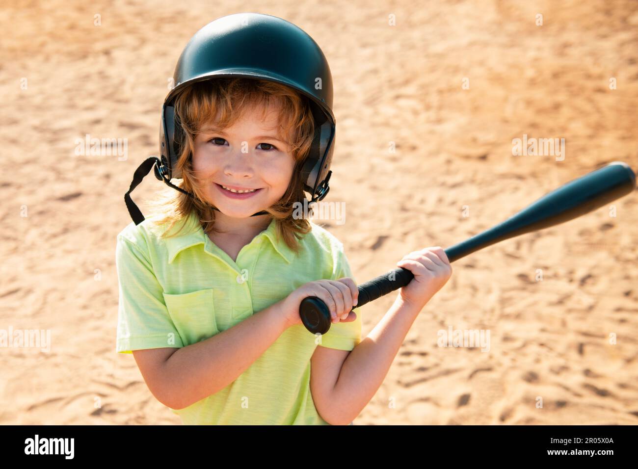 Child baseball player focused ready to bat. Kid holding a baseball bat ...