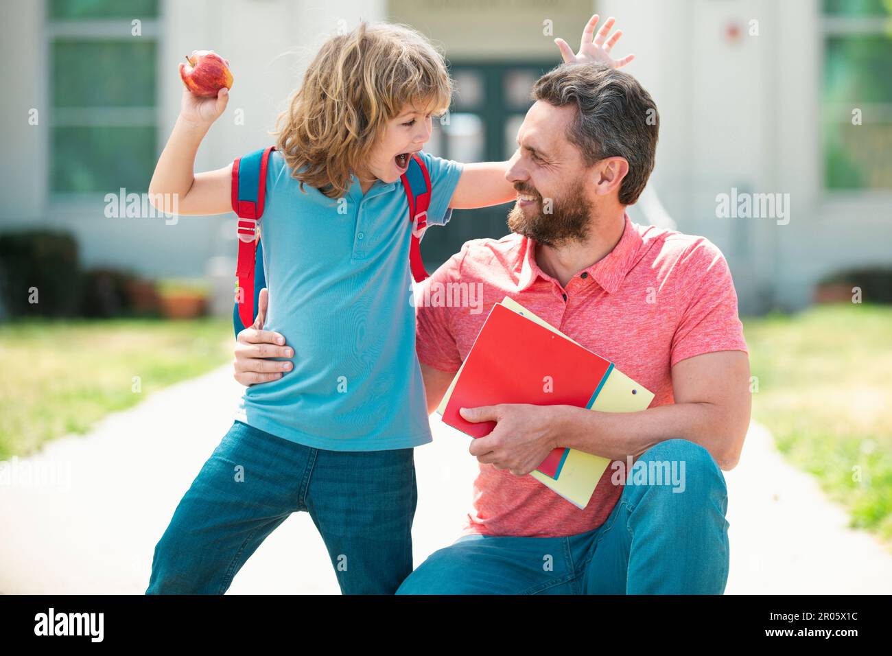 Father walking son to school. Father leads a little child school boy in ...