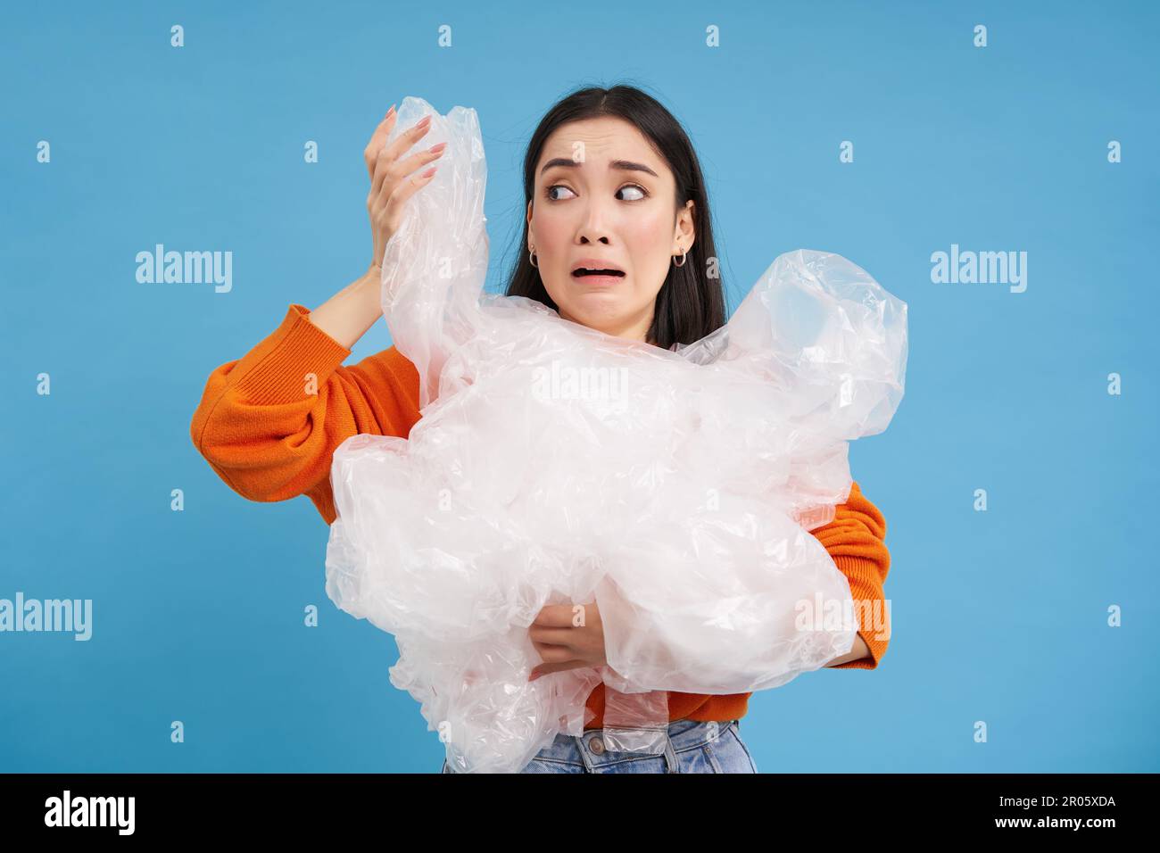 Crying asian woman with plastic recycling waste, tired of sorting ...