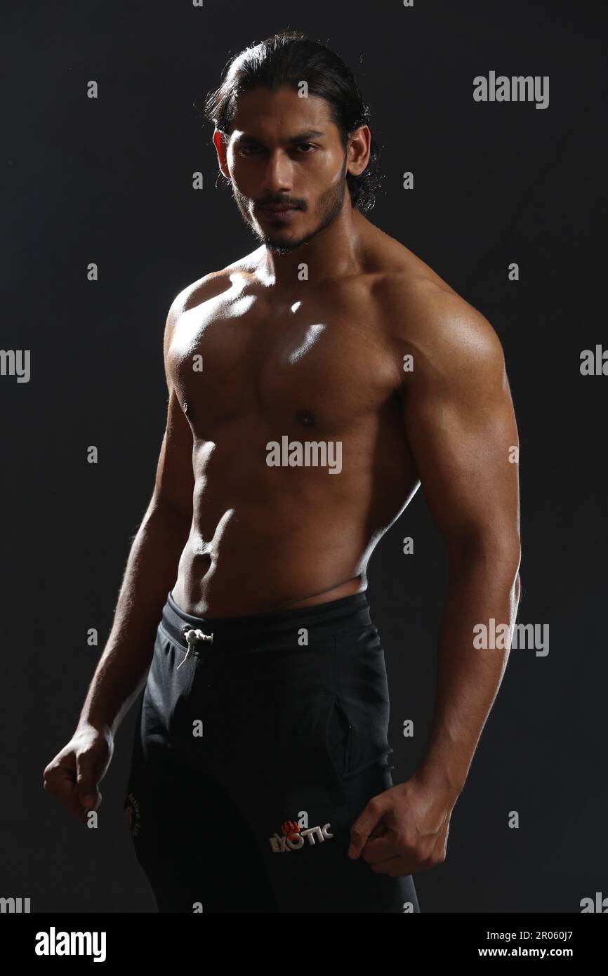 Portrait of muscular mid adult man in gym Stock Photo - Alamy