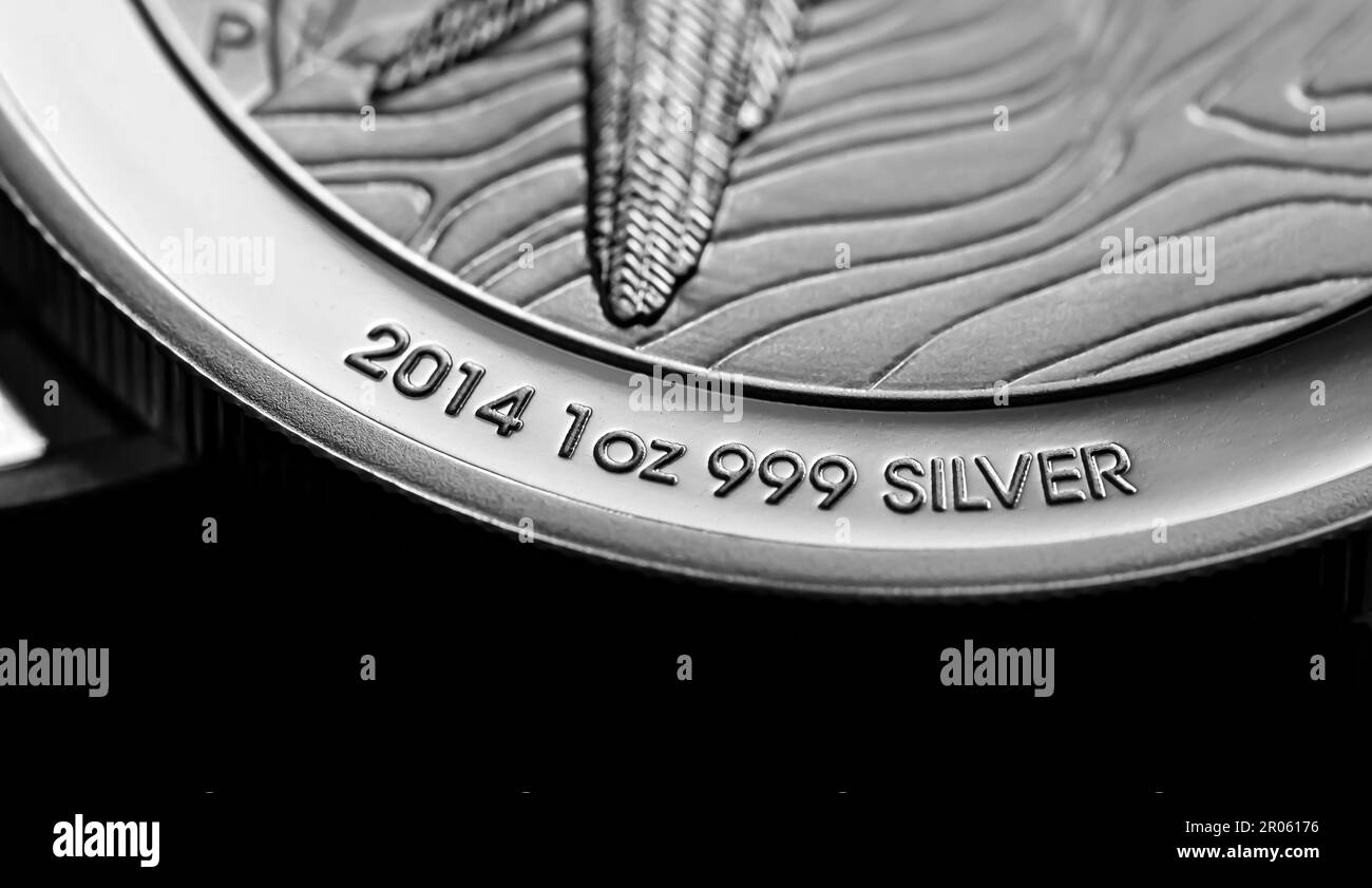 Macro Close up of Silver Bullion Coin on a black mirror background ...