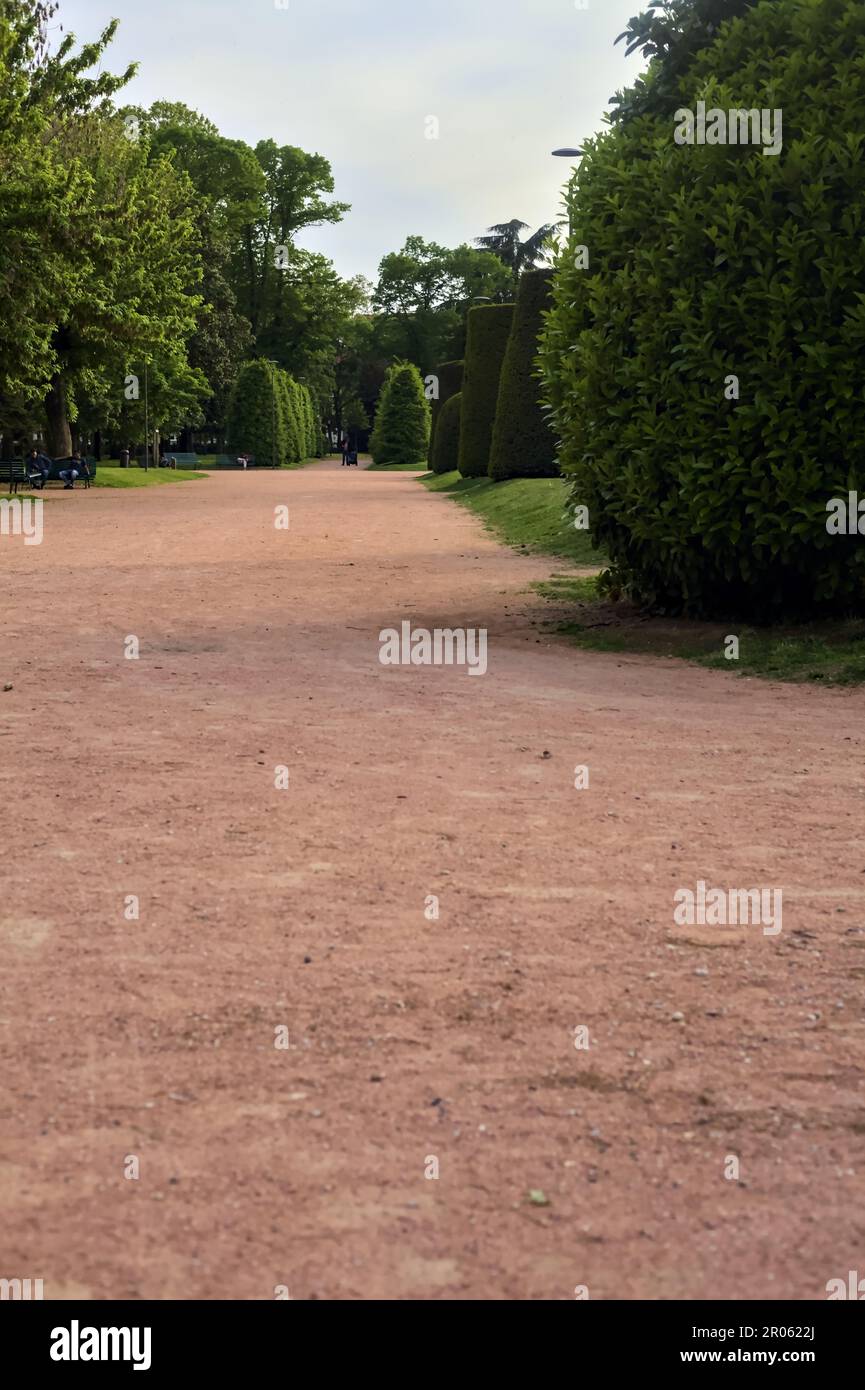 Path in a public park in an italian town at sunset Stock Photo - Alamy