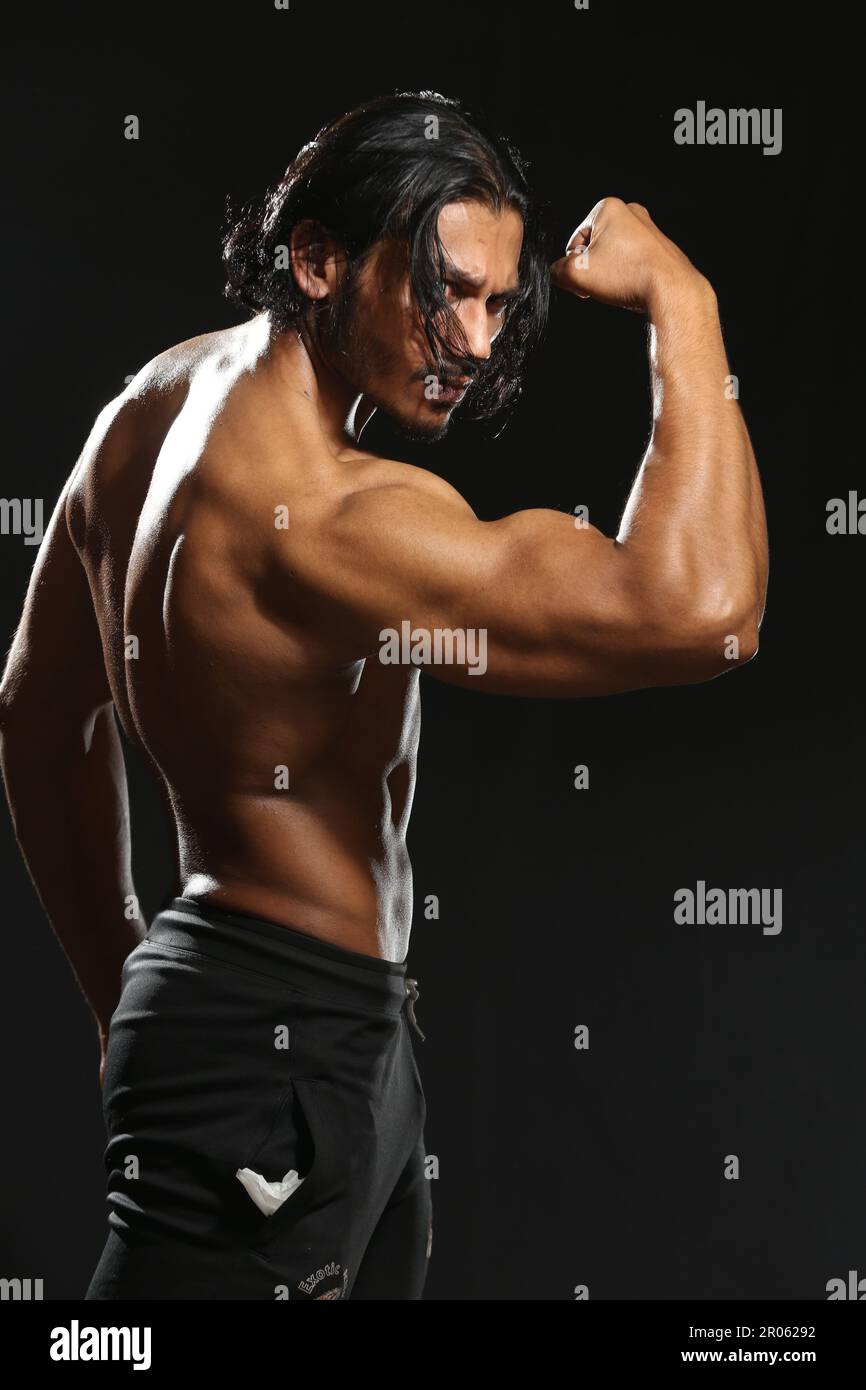 Portrait of muscular mid adult man in gym Stock Photo - Alamy