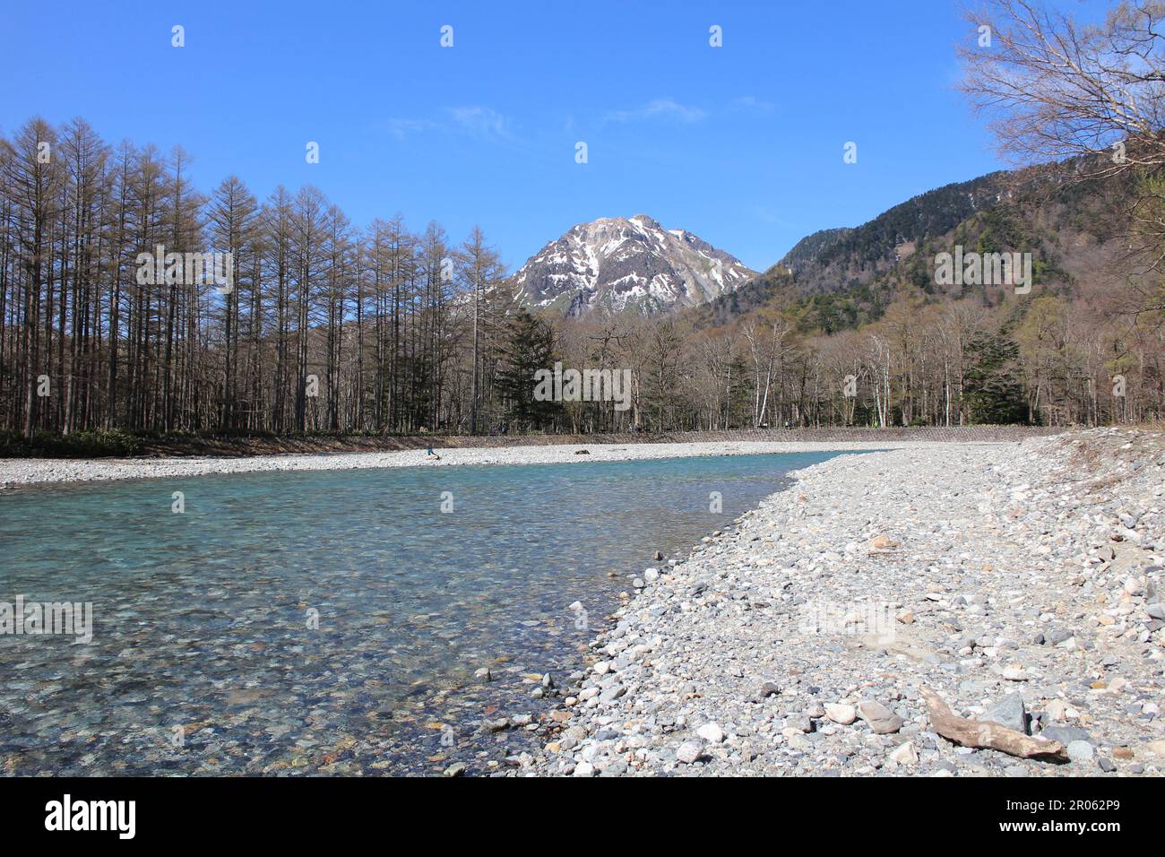 The clear Azusa River and snow-capped Mount Yakedake viewed from ...