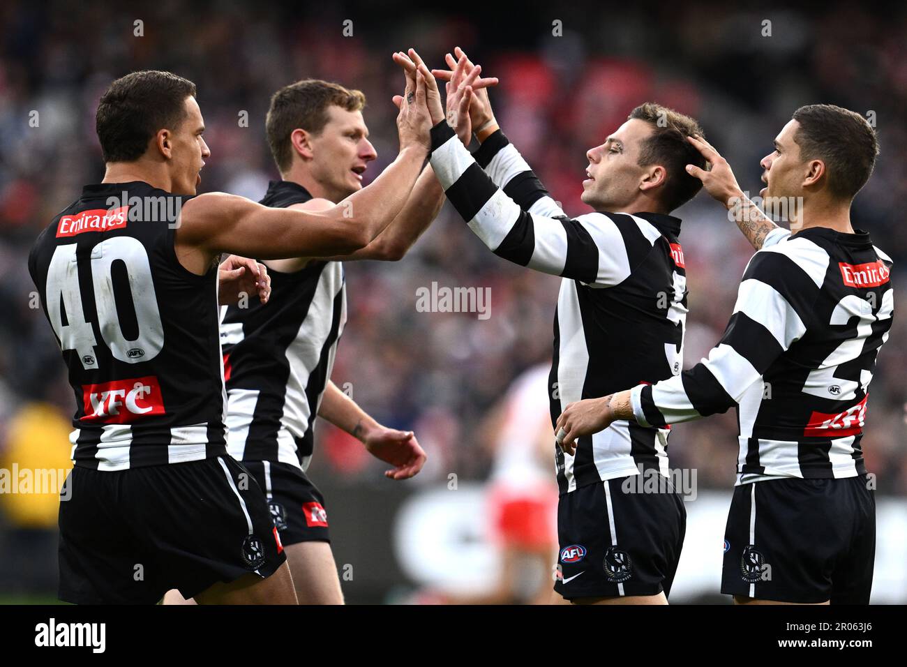 Jamie Elliott of Collingwood (2nd right) celebrates scoring a goal ...