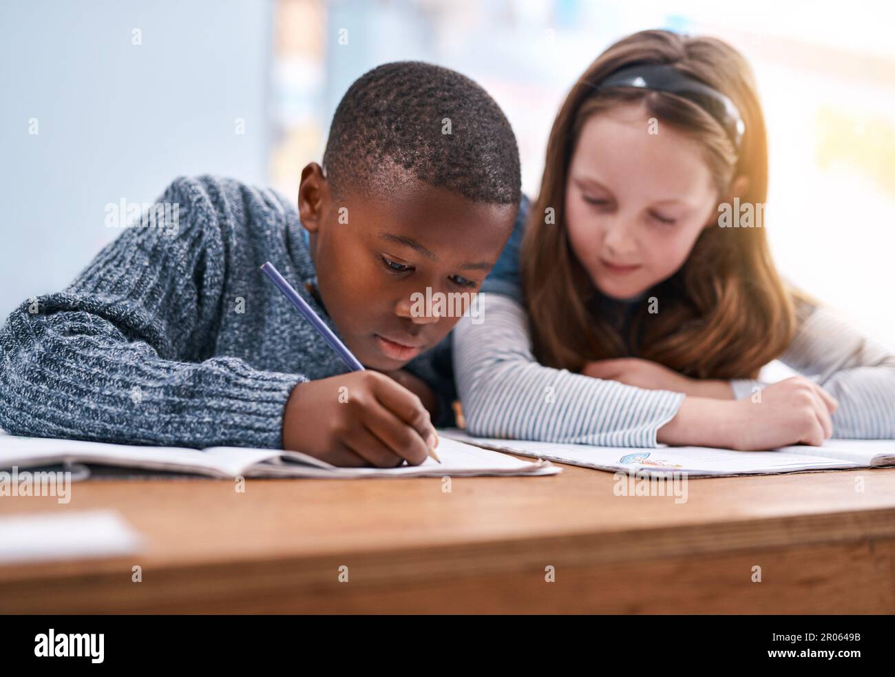 Oh so thats how its done. two elementary school kids doing school work ...
