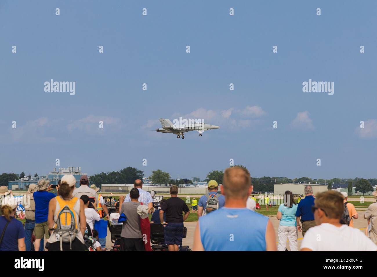 An audience of onlookers observe Boeing EA-18G fighter jet landing at ...