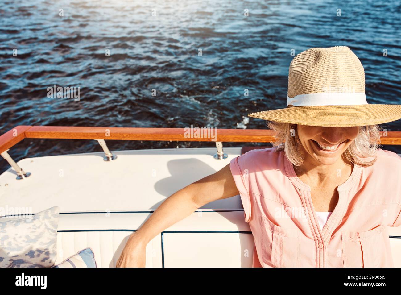 The ideal place to unwind. a mature woman enjoying a relaxing boat ride ...