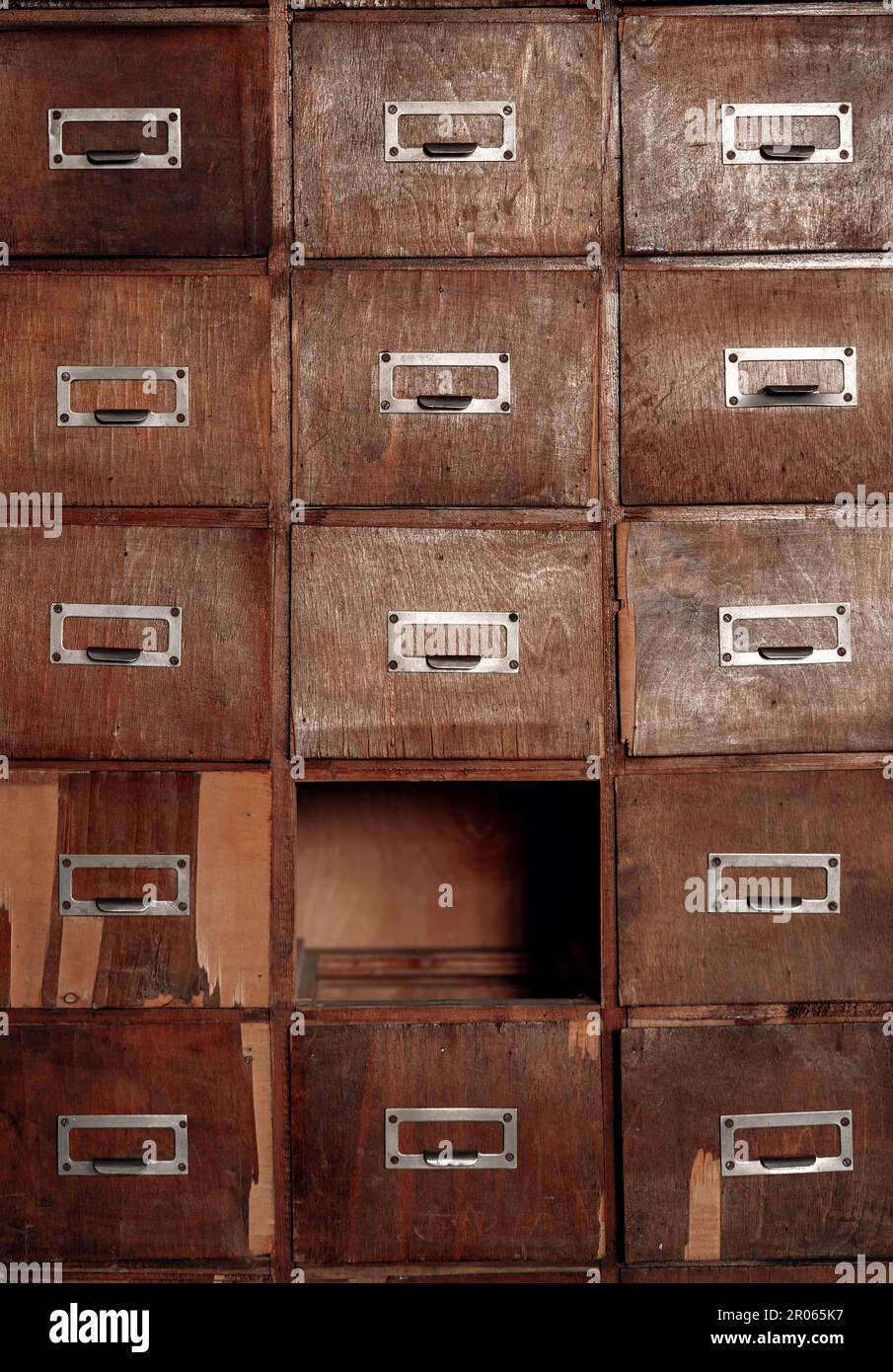 Broken wooden vintage cabinet with missing drawers. Library card or ...