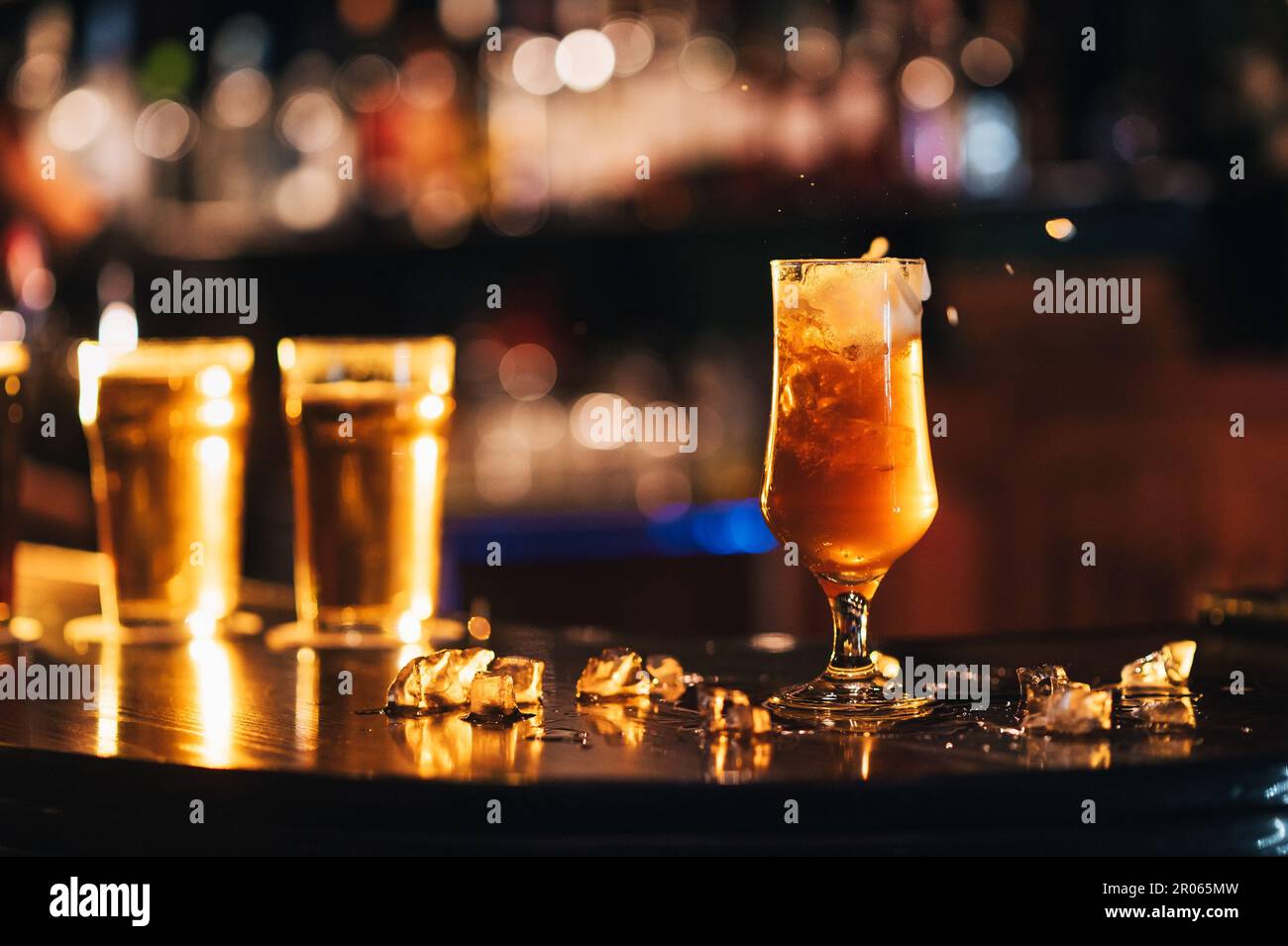 glass of light unfiltered draft beer with on bar counter with drops of ...