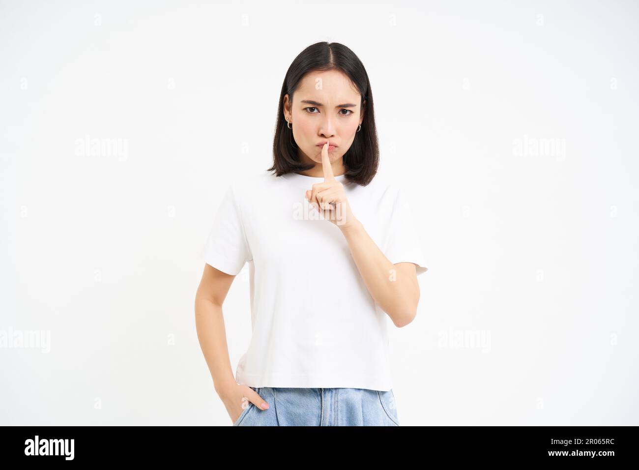 Portrait of girl shushes, shhh gesture, speaks silently, taboo to say ...