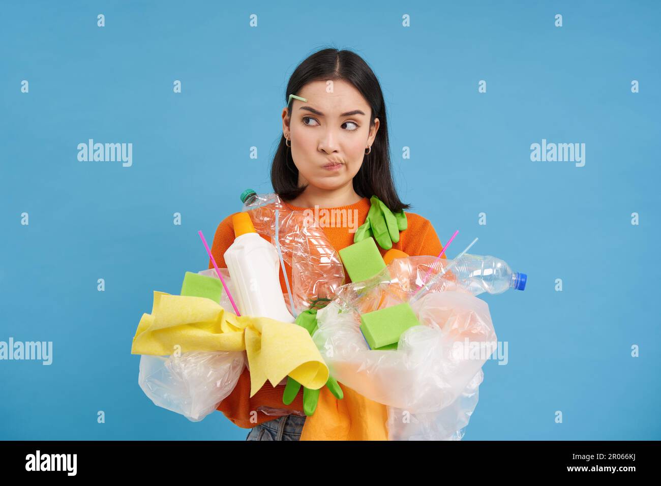 Eco woman holding plastic bottles and recycling waste, thiking, looking ...