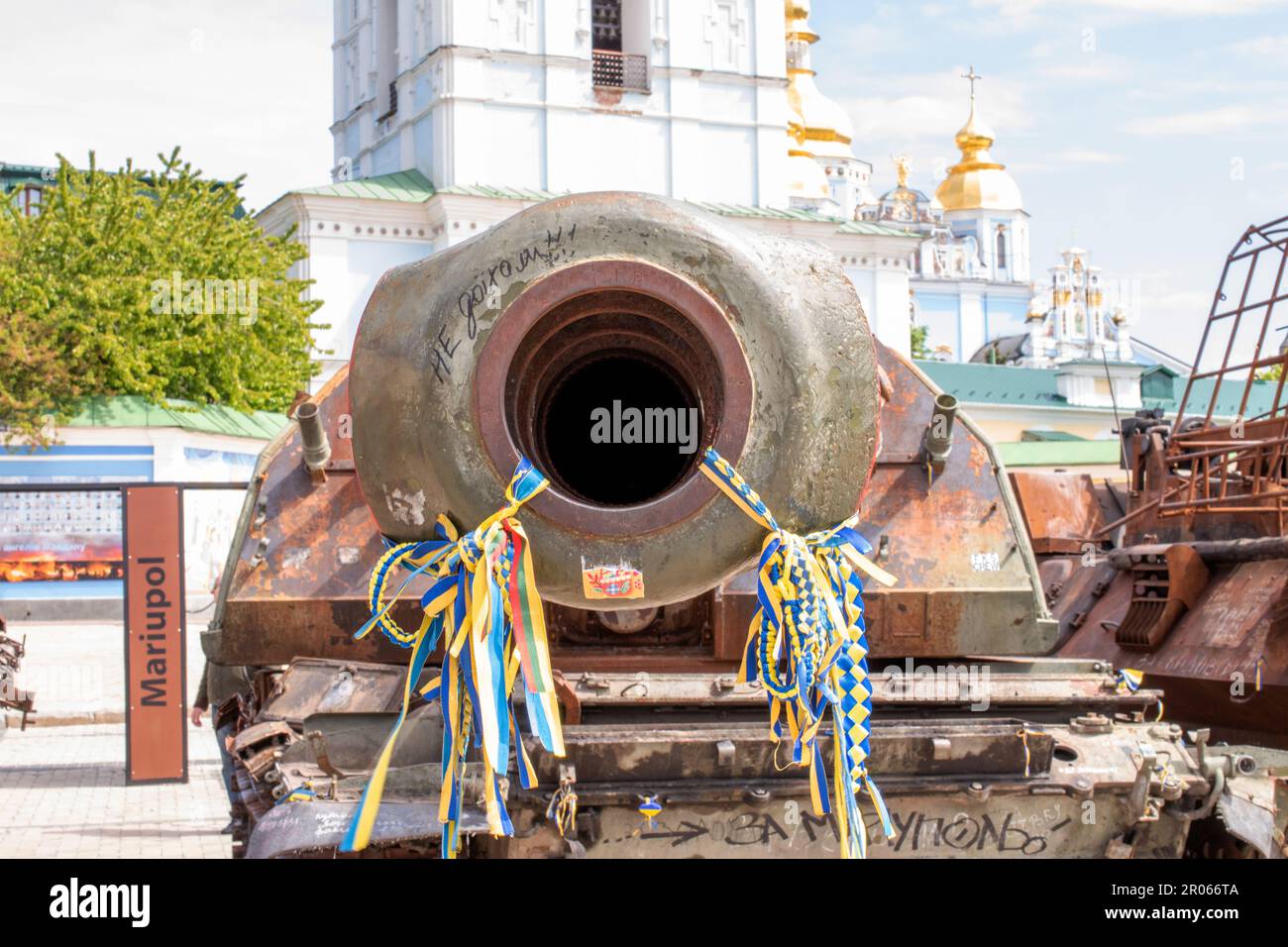 The barrel of a burnt russian tank with Ukrainian yellow and blue ...