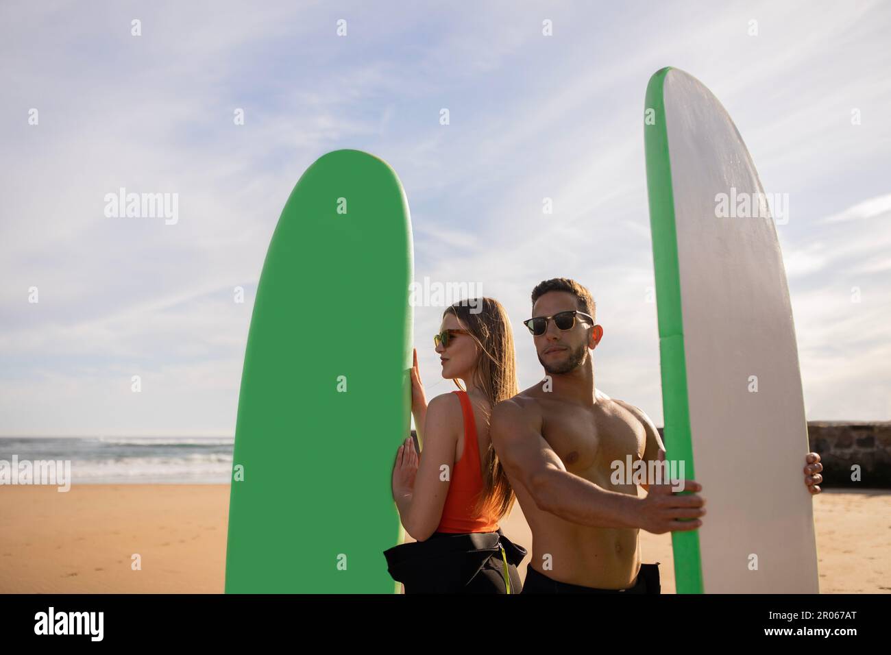 Beautiful Young Couple Posing With Surf Boards On Beach In Summer Stock ...