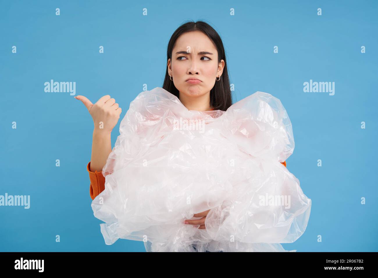 Unhappy korean woman with plastic waste, collecting garbage and ...