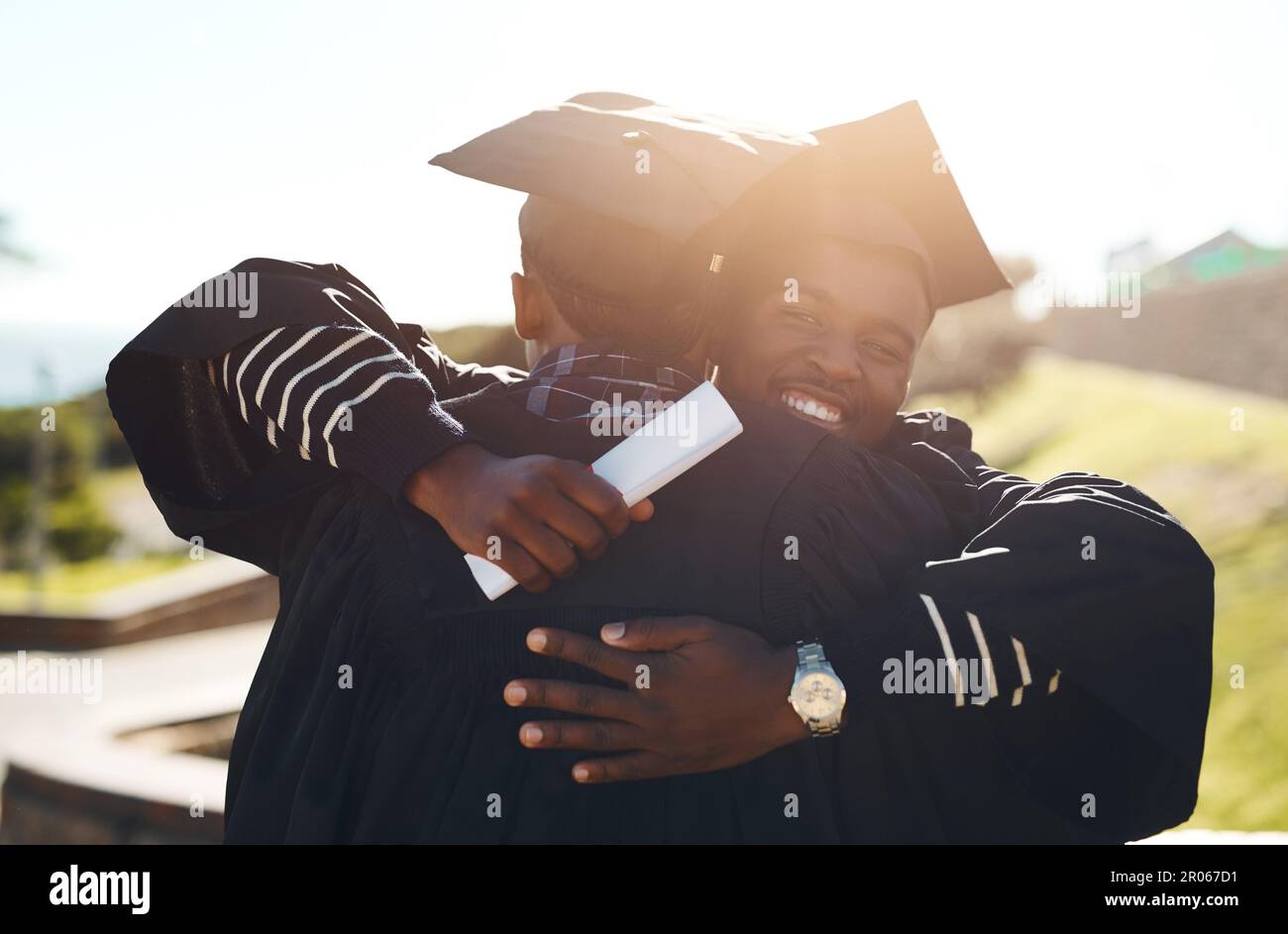 Go into the world and do good. two happy young students hugging each ...