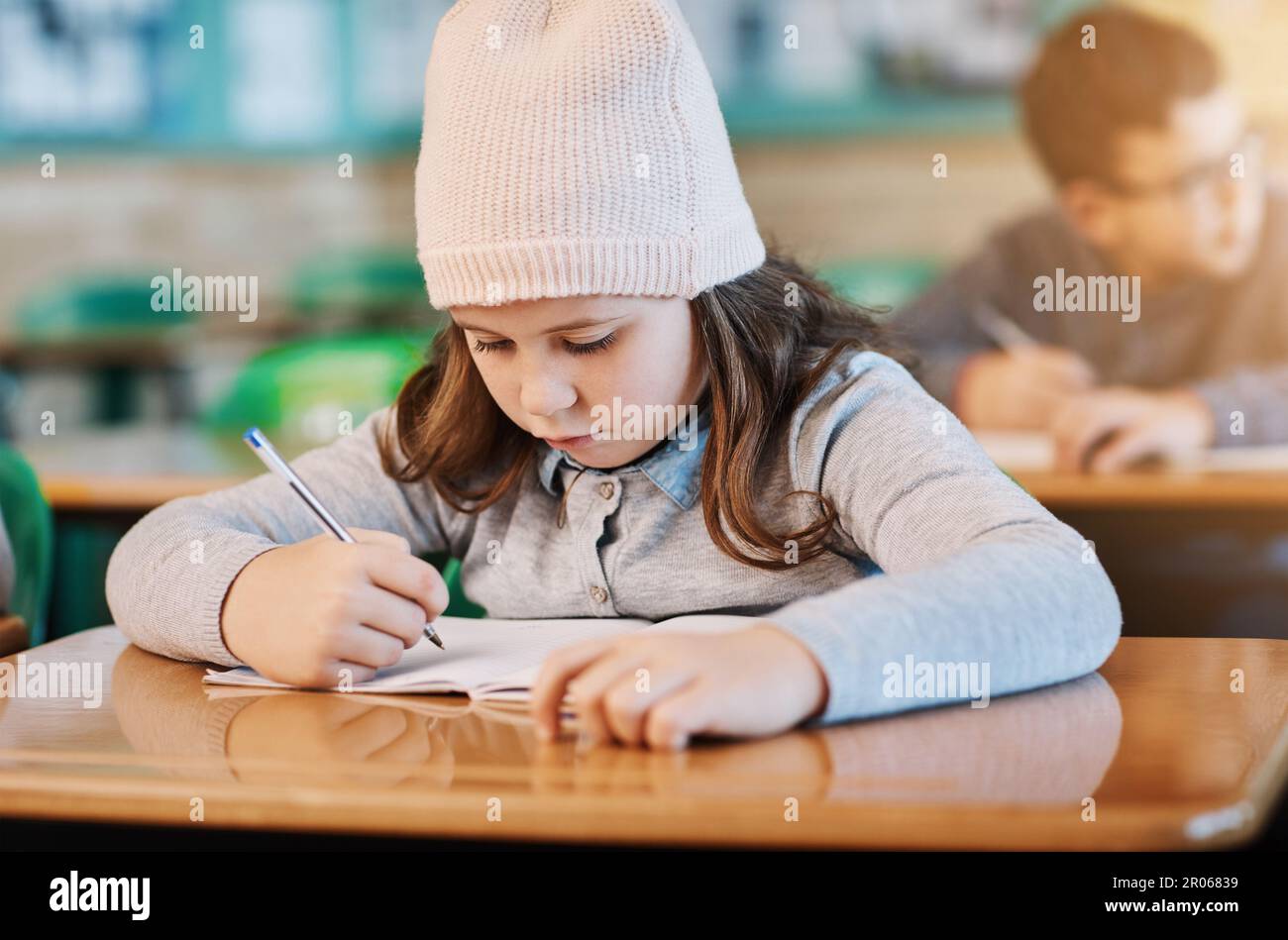 Concentrated on getting her schoolwork done. an elementary school girl ...