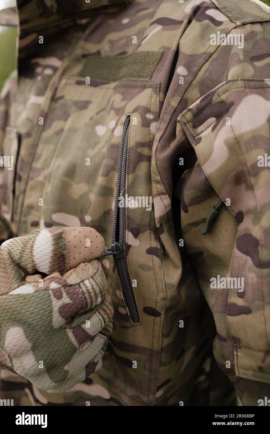 Preparing for Combat: Close-up of Soldier Putting on Gear in the Field ...