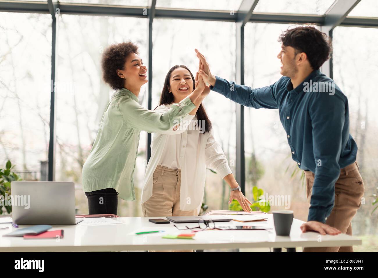 Multicultural Team Of Colleagues Giving High Five Celebrating Success ...