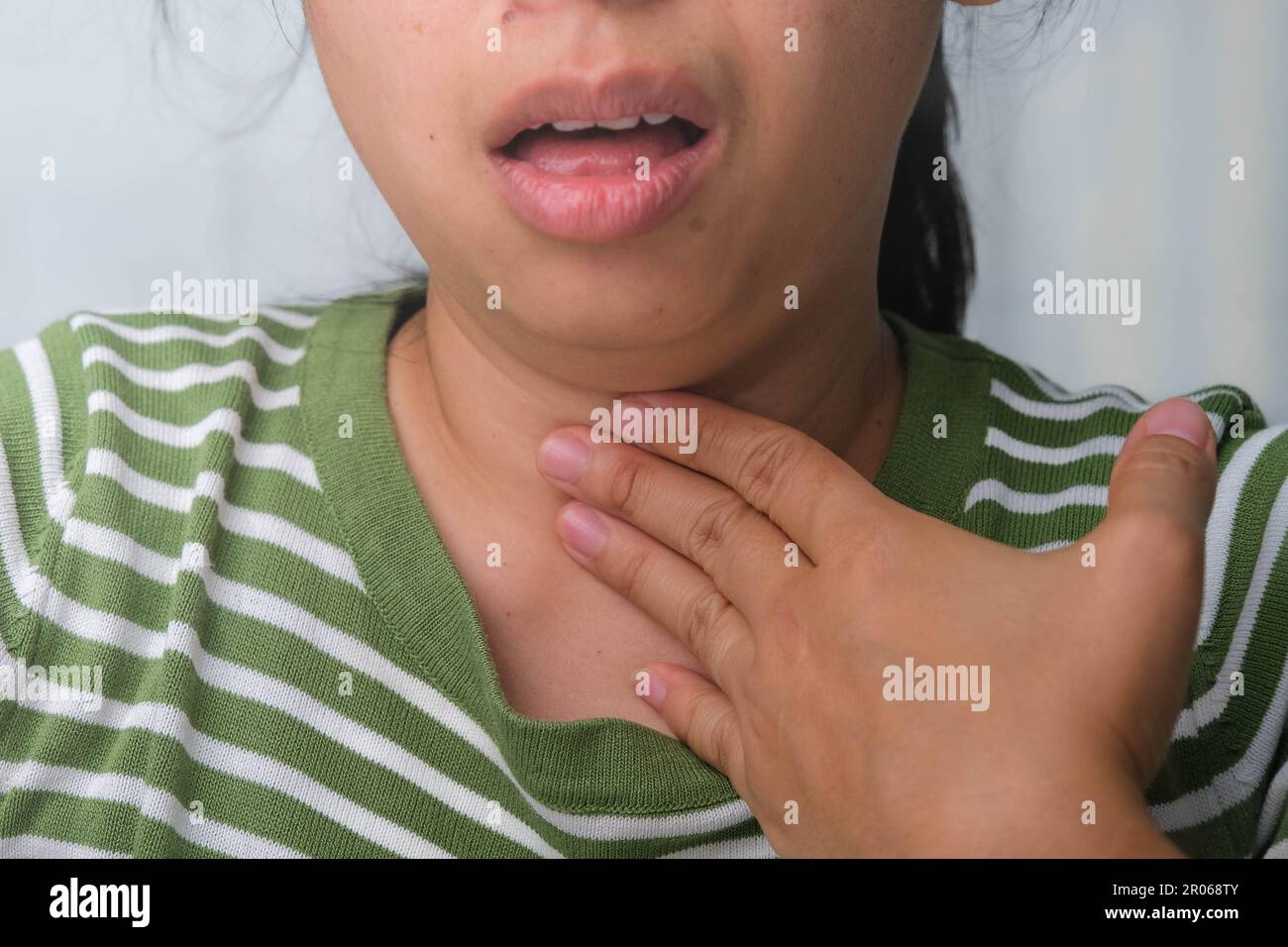 Young woman touching painful throat, sore throat flu, cold and ...