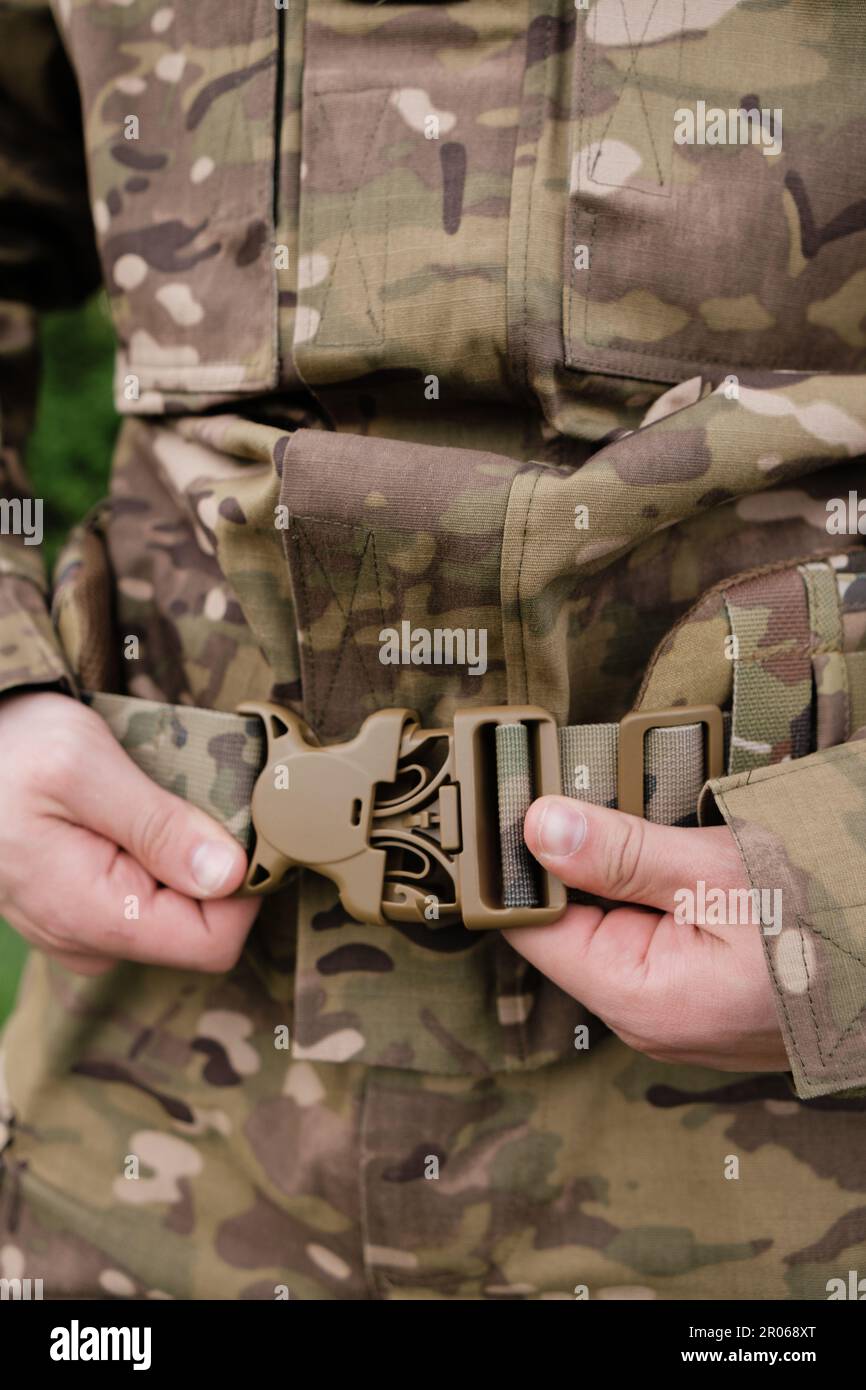 Preparing for Combat: Close-up of Soldier Putting on Gear in the Field ...