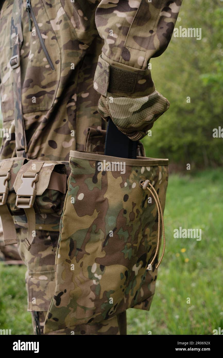 Preparing for Combat: Close-up of Soldier Putting on Gear in the Field ...