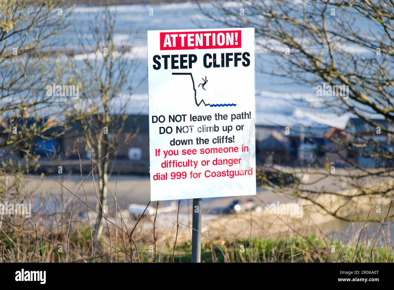 Steep cliffs warning sign for tourists high above Stonehaven harbour ...