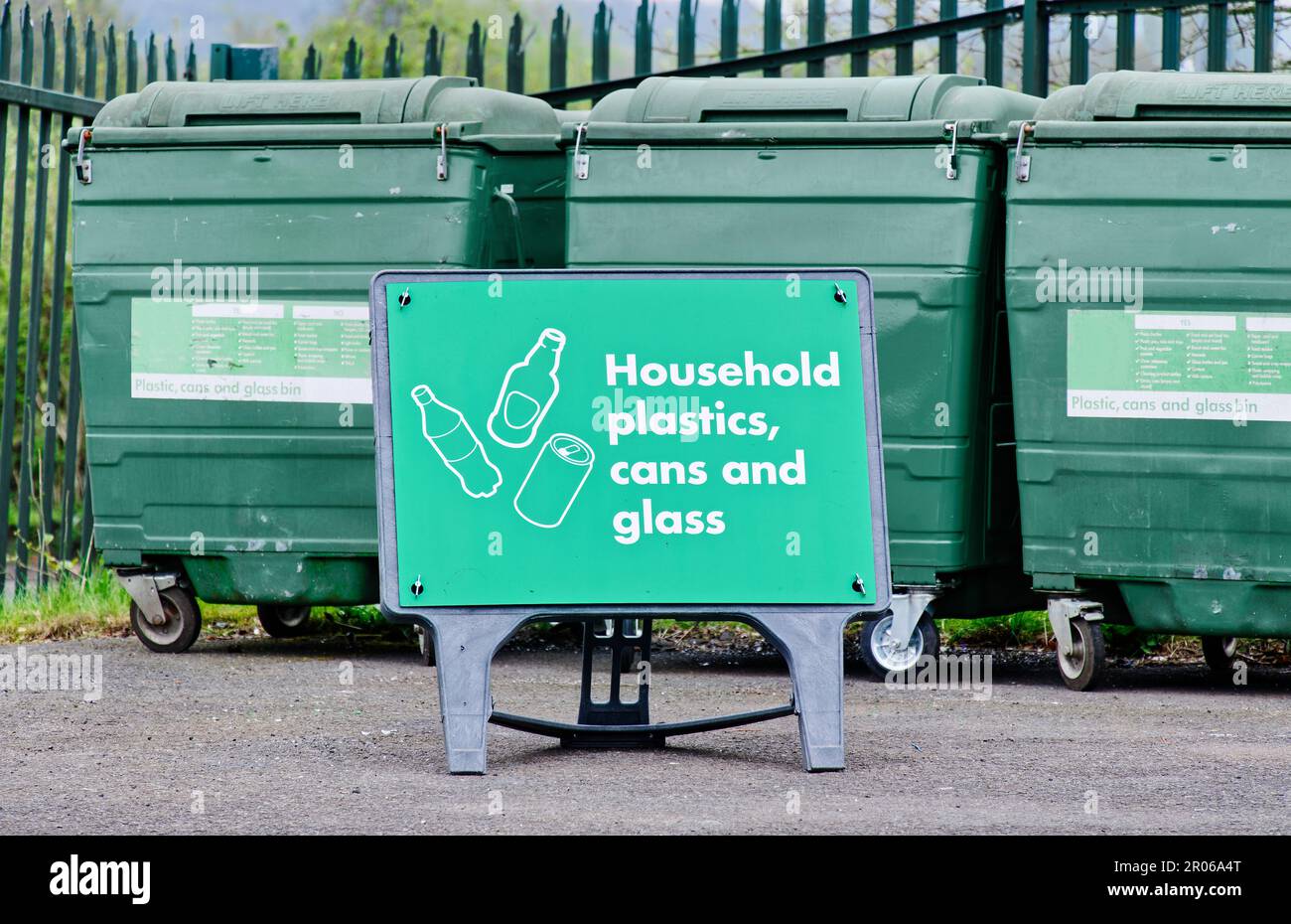 Household plastics, cans and glass recycling containers and sign Stock ...