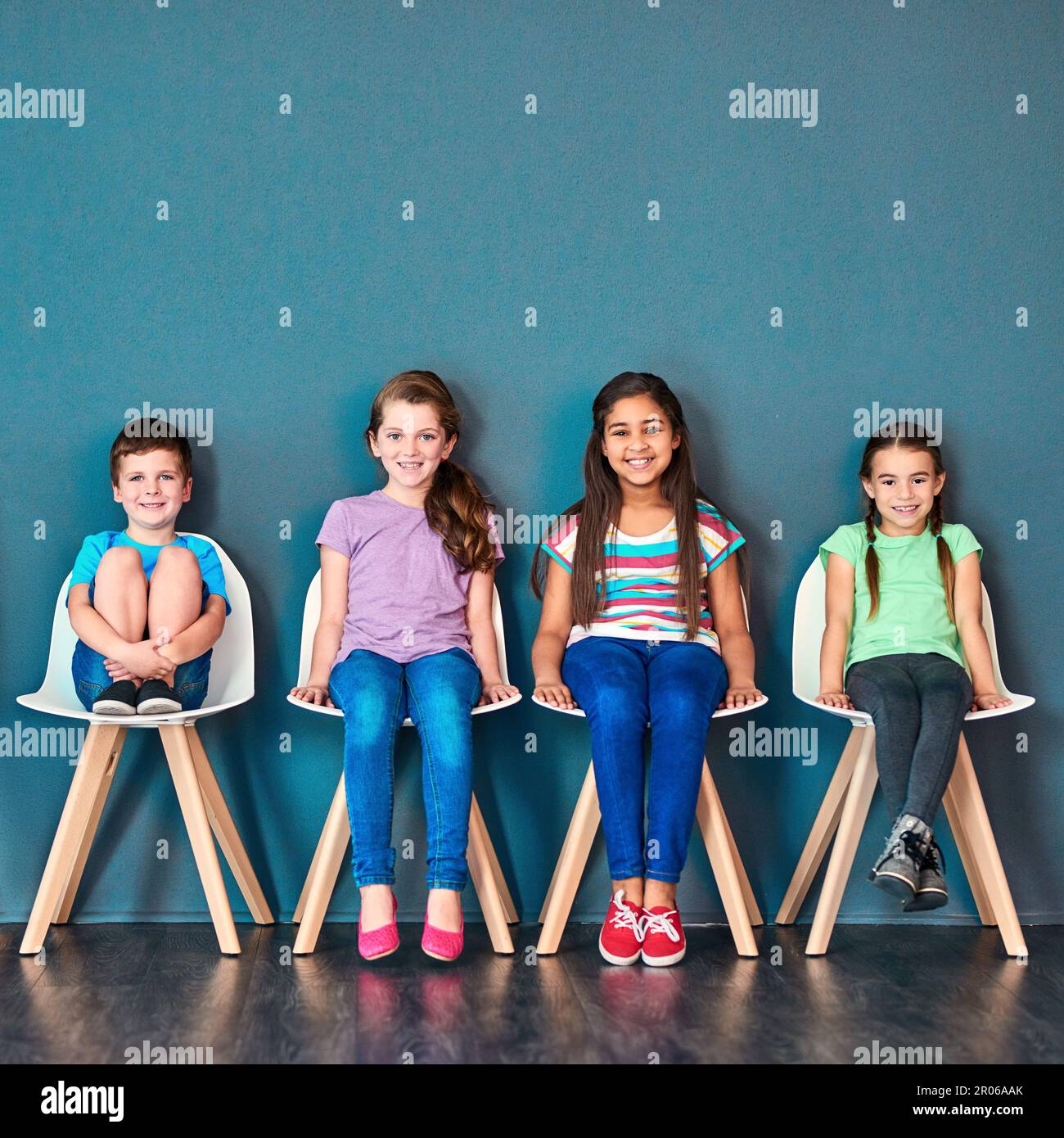 Its our turn now. Studio portrait of a diverse group of kids sitting on ...