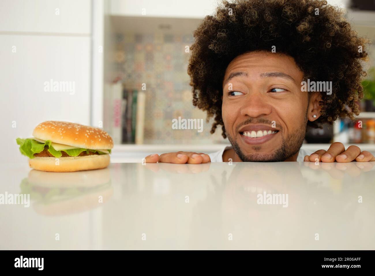 Man eating black burger home hi-res stock photography and images - Alamy